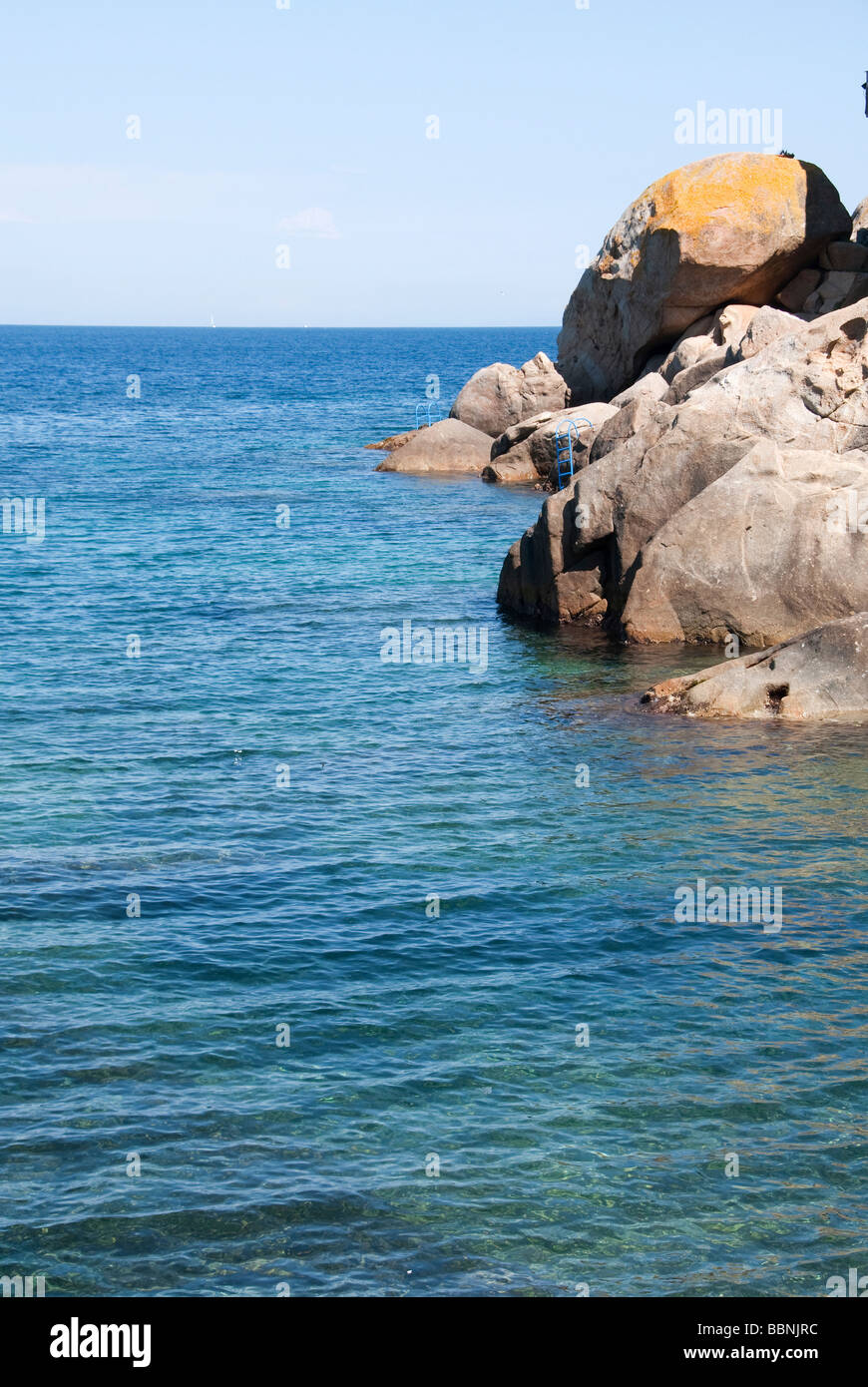 blue ladders let swimmers decend into the sea off the rocks at Island ...