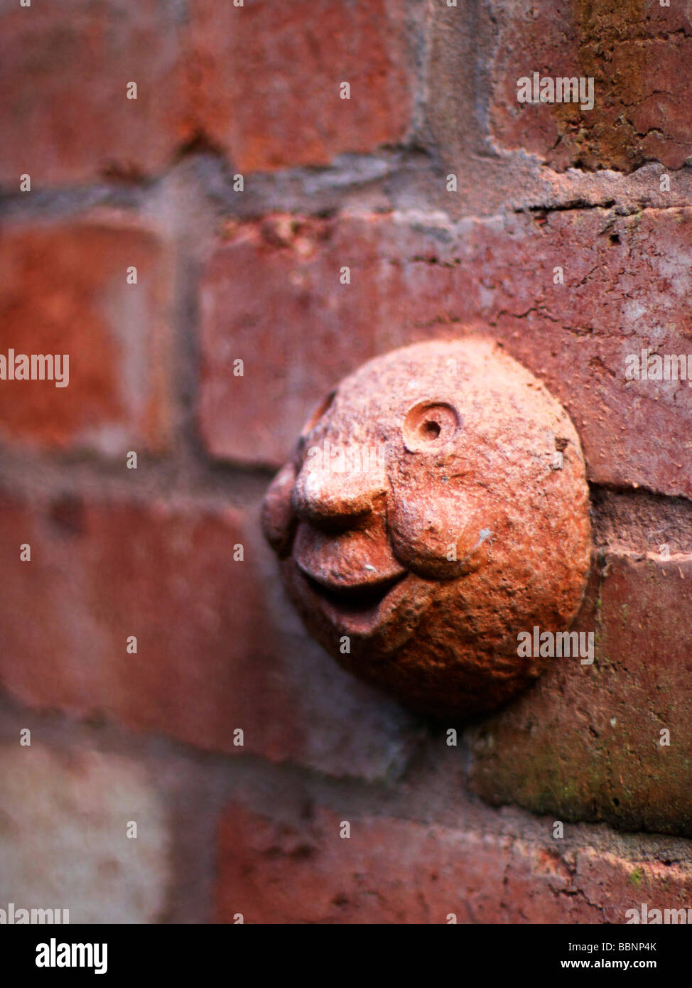 brick face on wall of house smile smiling Stock Photo - Alamy