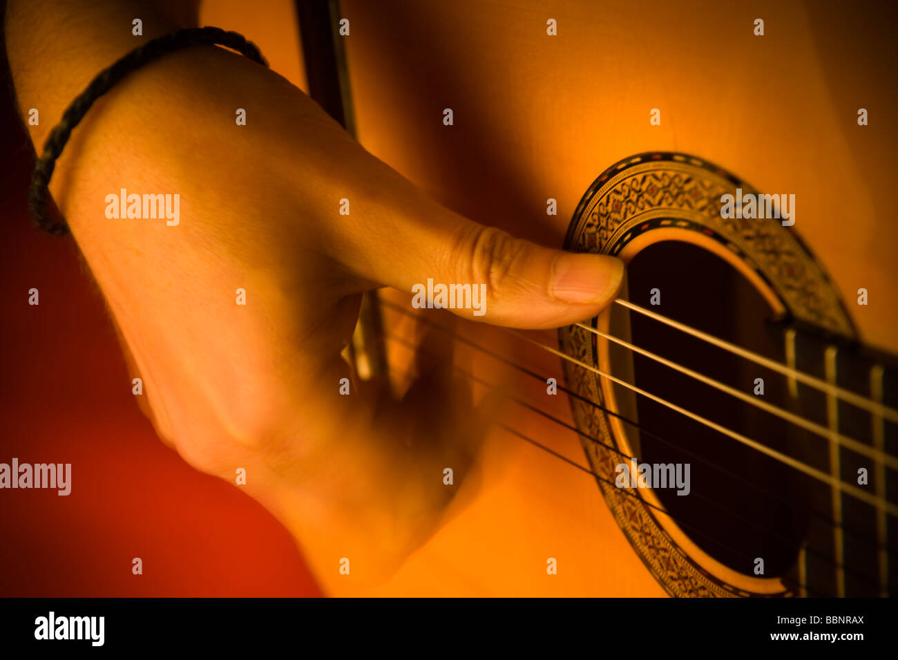 Flamenco guitar and guitarist's hand strumming Stock Photo - Alamy