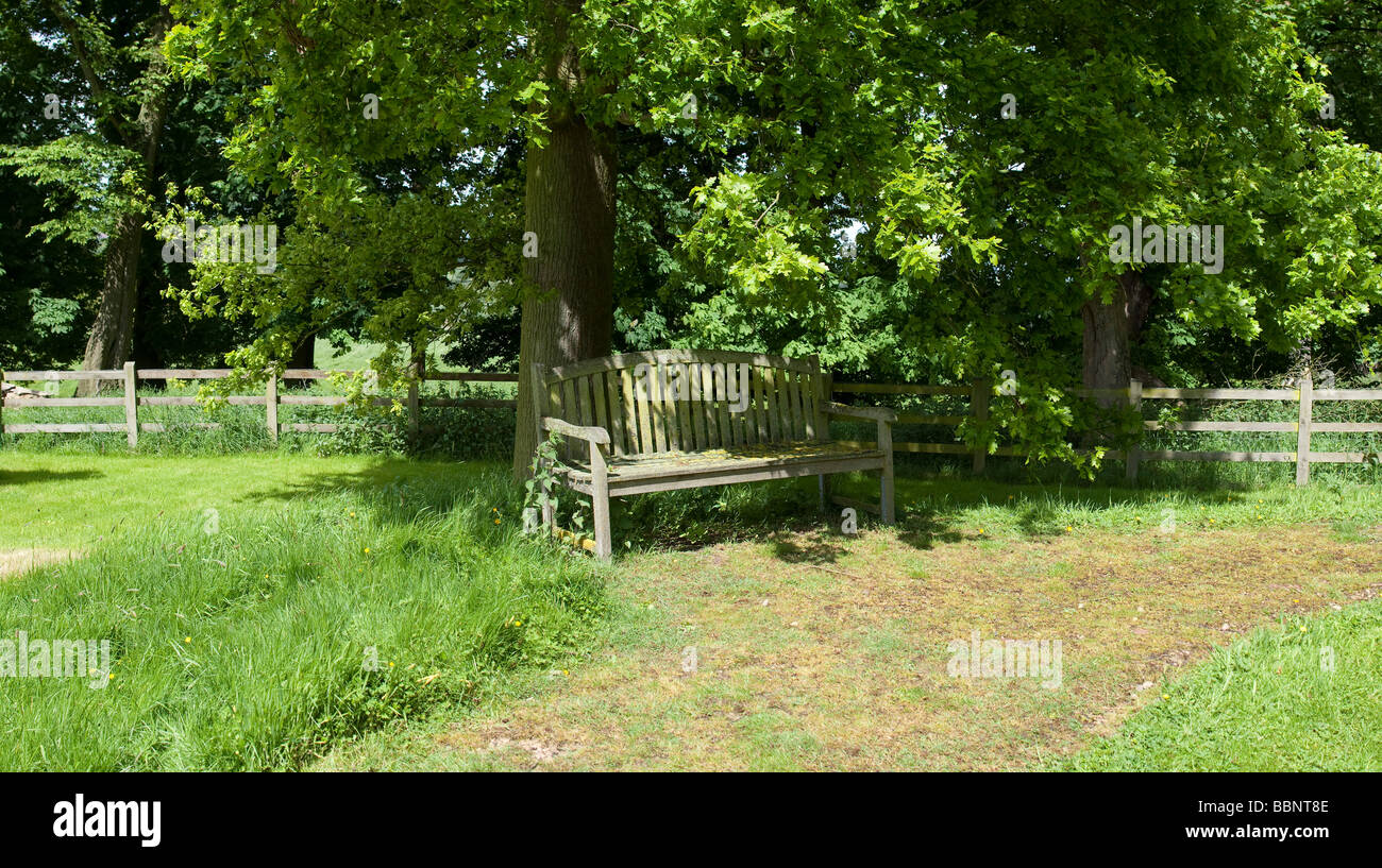 a bench in a country garden Stock Photo - Alamy