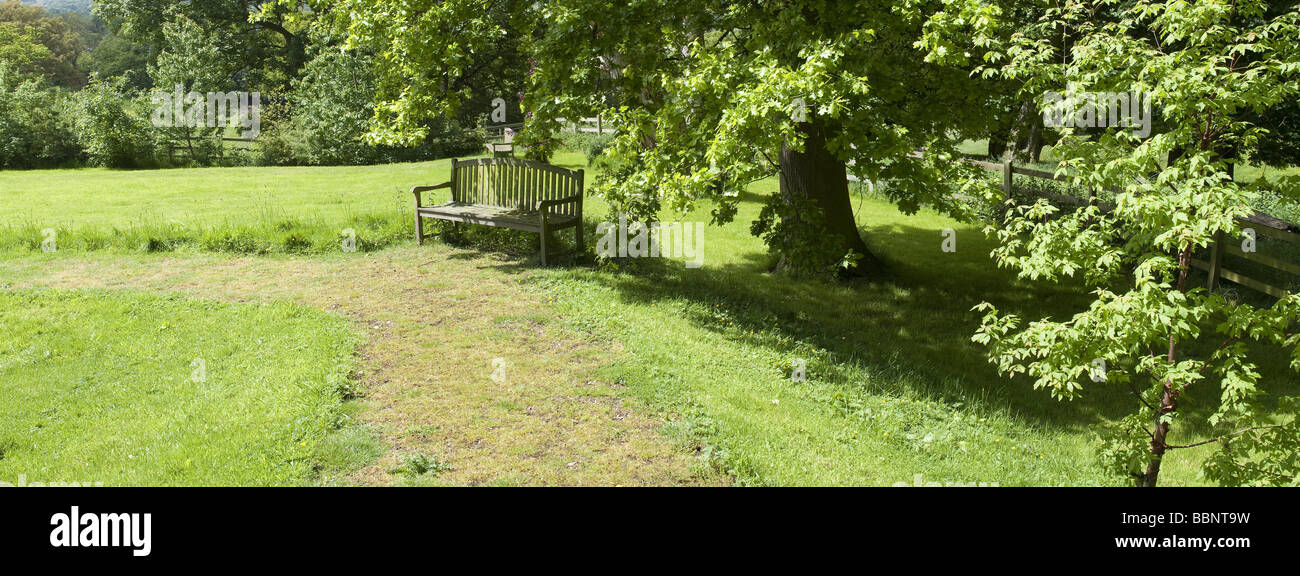 a bench in a country garden Stock Photo - Alamy