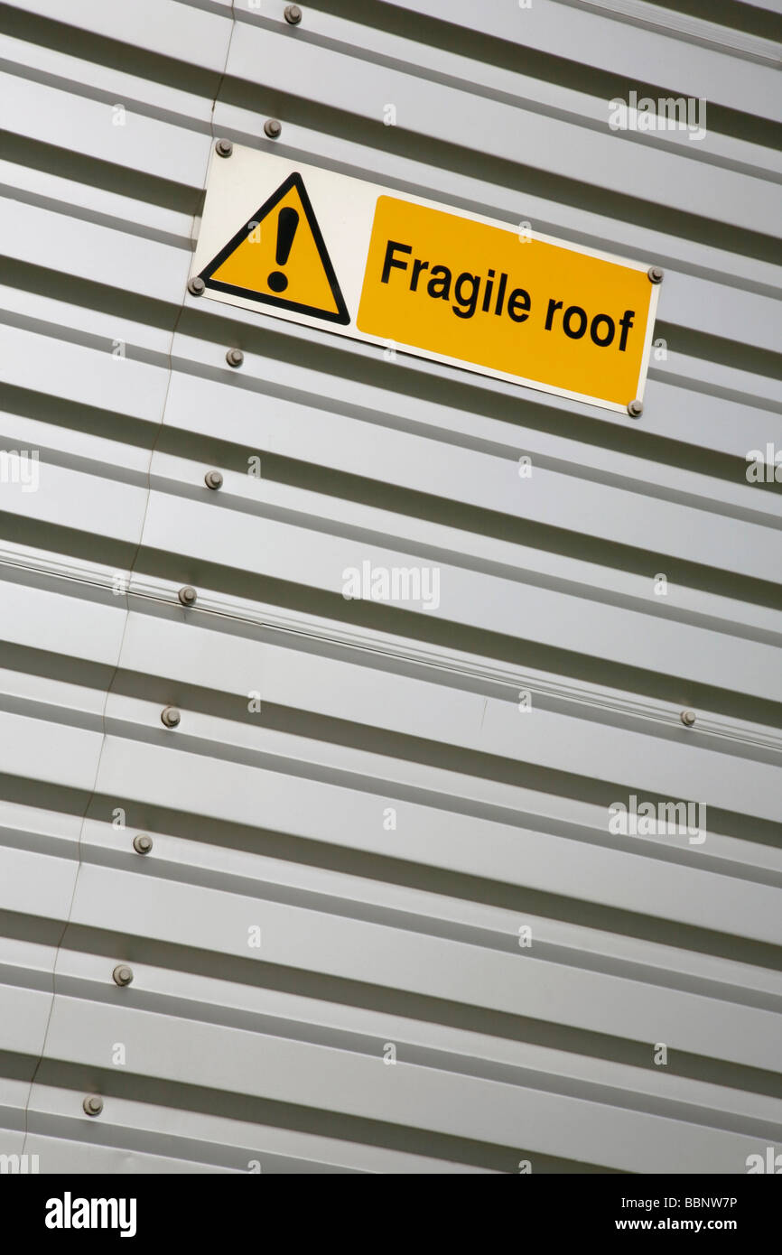 Fragile Roof warning sign on side of metal cladded building Stock Photo ...