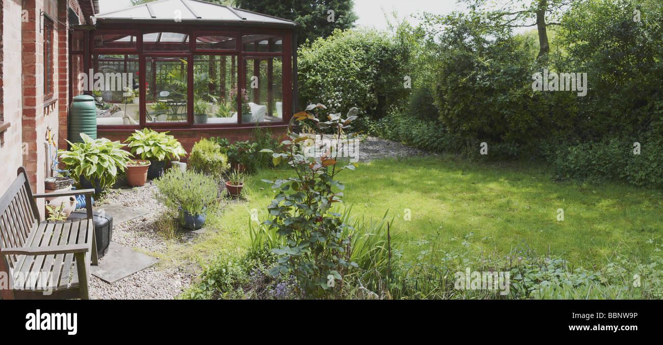 conservatory tables chairs plants room in house next to garden Stock ...
