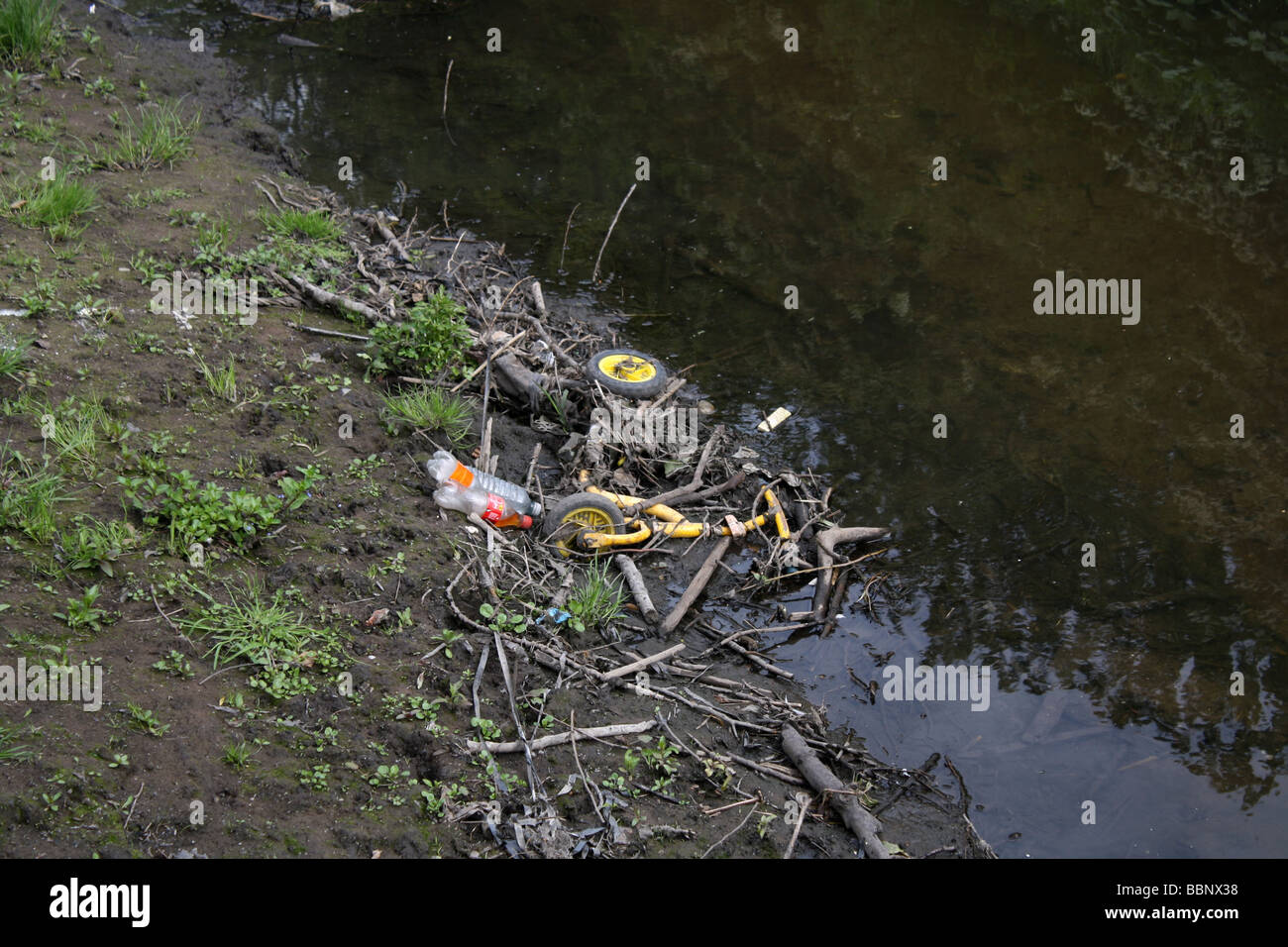 Children bike dumped in river Stock Photo - Alamy