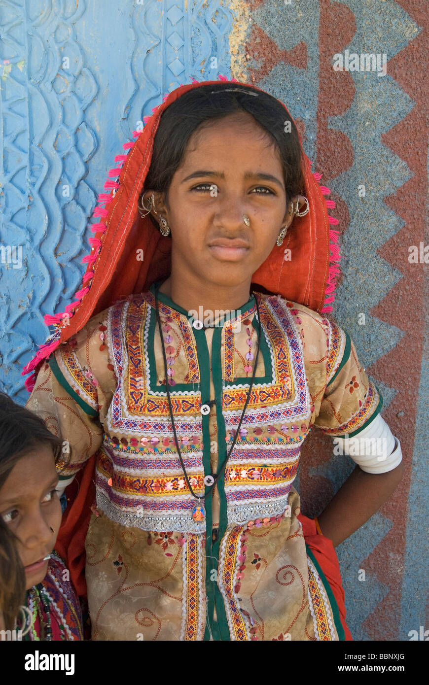 Kutchi girl in tribal costume leaning against bhunga wall, Hodka ...