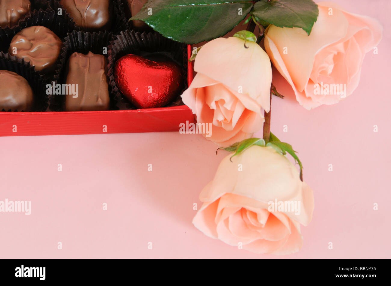 sweetBox of Chocolates with Pink Roses Stock Photo - Alamy