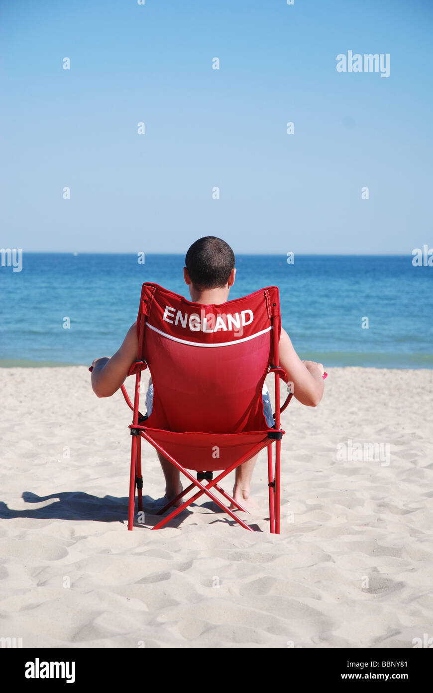 Man on deckchair at the beach Stock Photo - Alamy