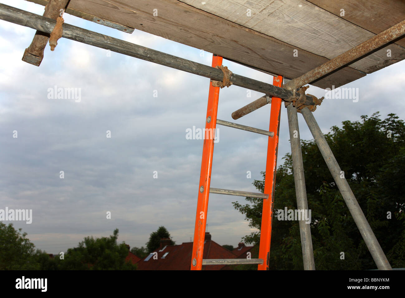 Scaffolding and orange ladder Stock Photo - Alamy