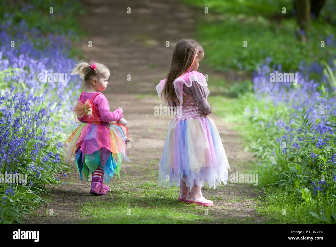 Two young children in fairy dresses enjoying the enchantment of a ...