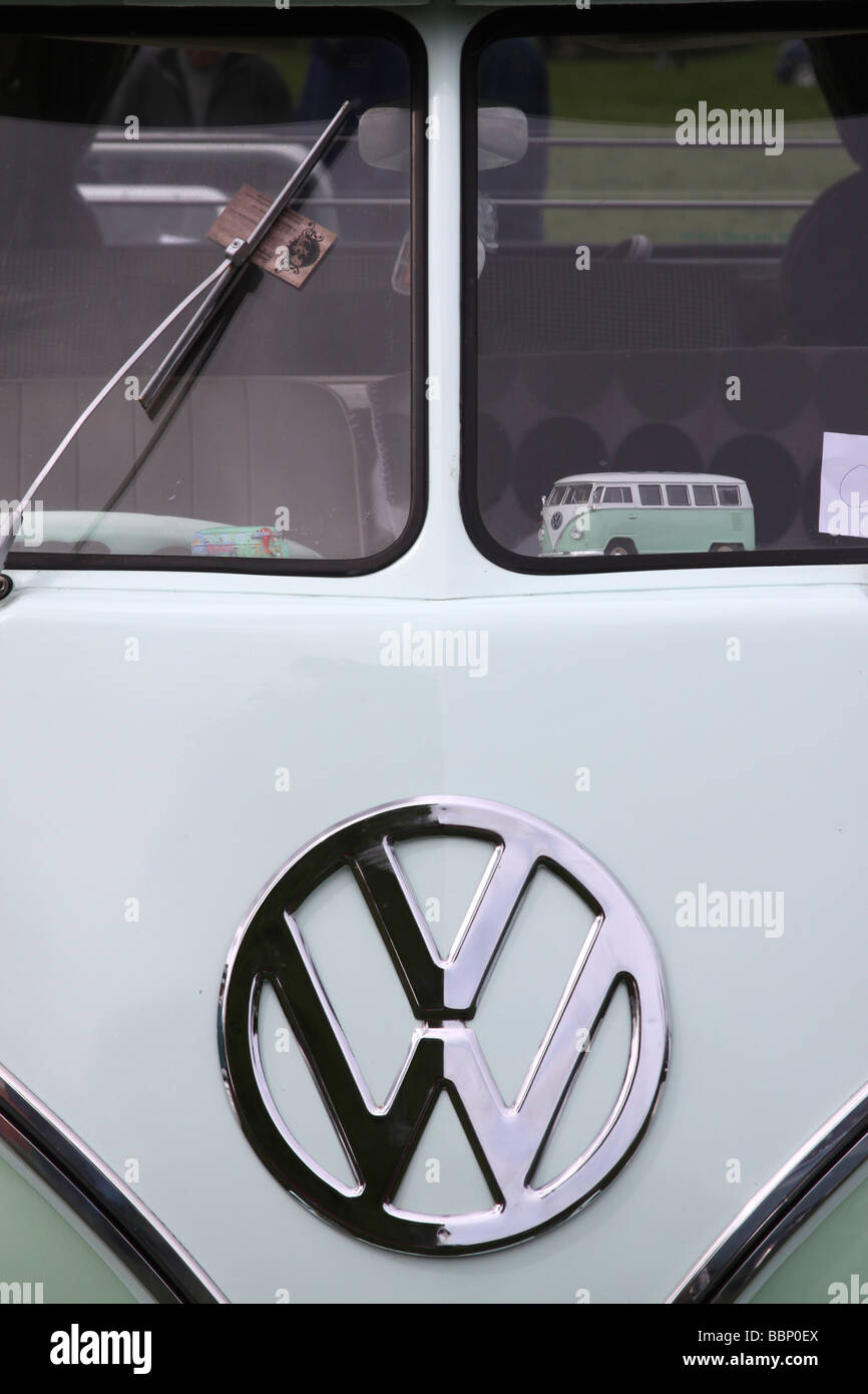 Front of a green and white VW camper van showing the VW badge and a ...