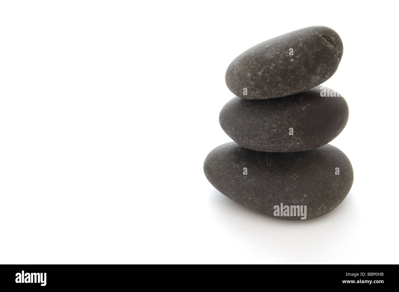 Stack of three basalt pebbles on white background Stock Photo - Alamy