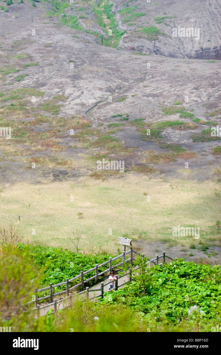 A little boy down in the crater of the still active volcano Mt Usu zan ...