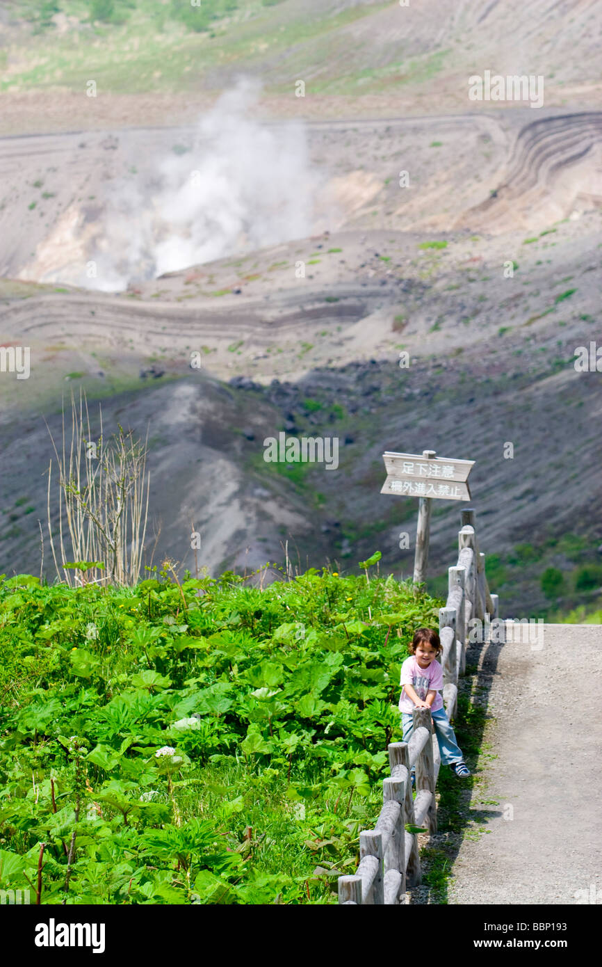 A young boy poses in the smouldering crater of the still active volcano ...