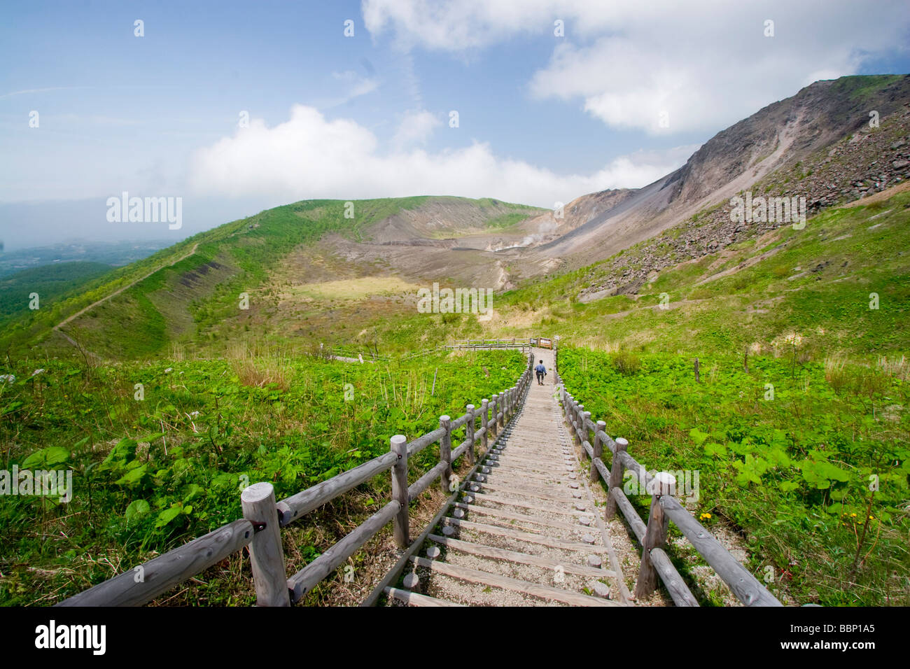 A set of long wooden stairs leads down into the crater of the still ...