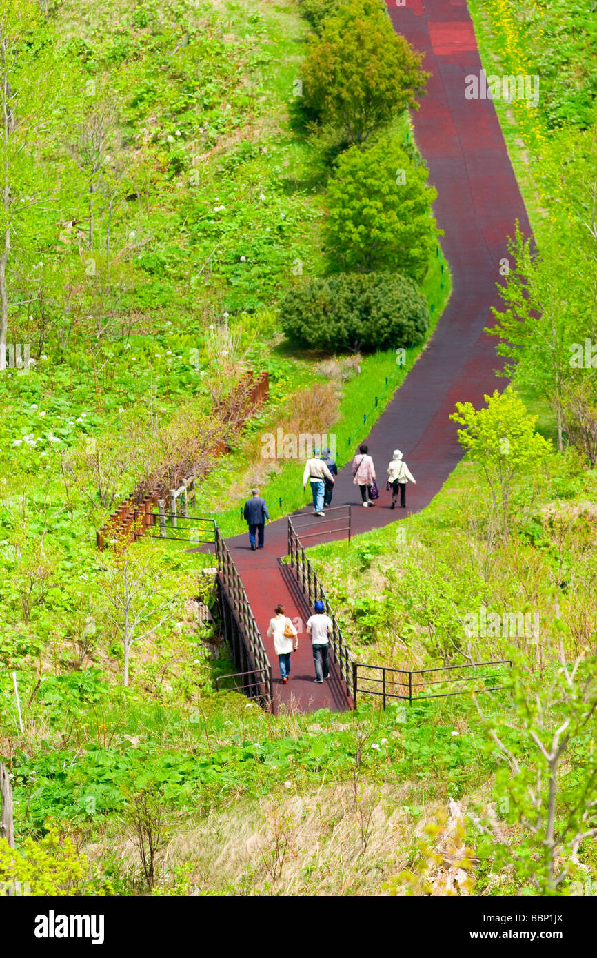 A long red path leads visitors up to the crater of Mt Usu zan a still ...