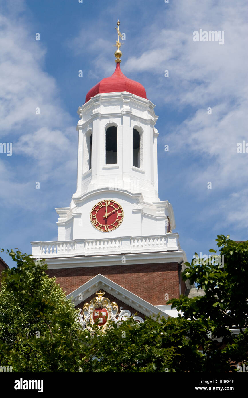 Red cupola dome with gold weather vane on clock tower against blue sky ...