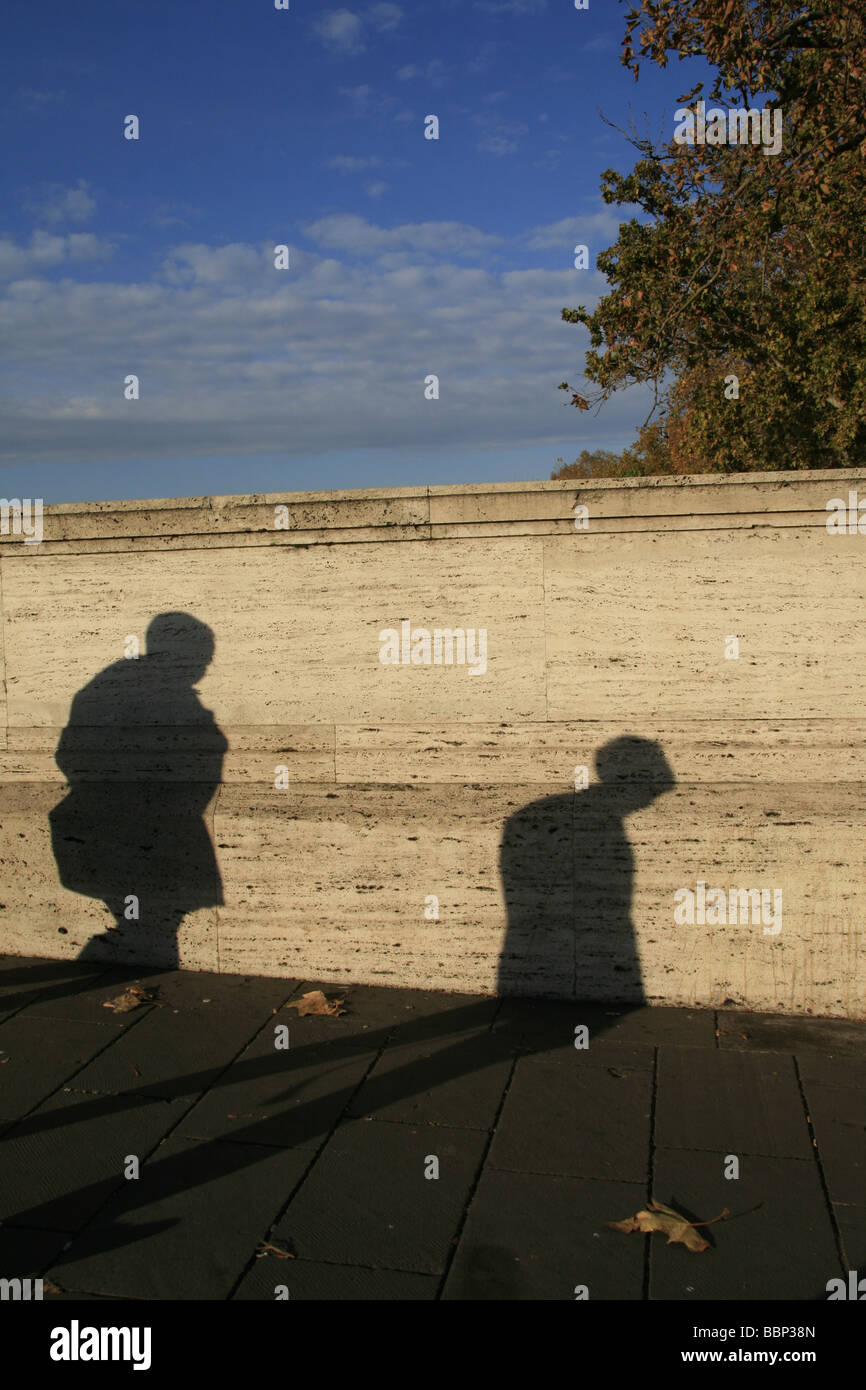 two people's shadow on wall in city town Stock Photo - Alamy