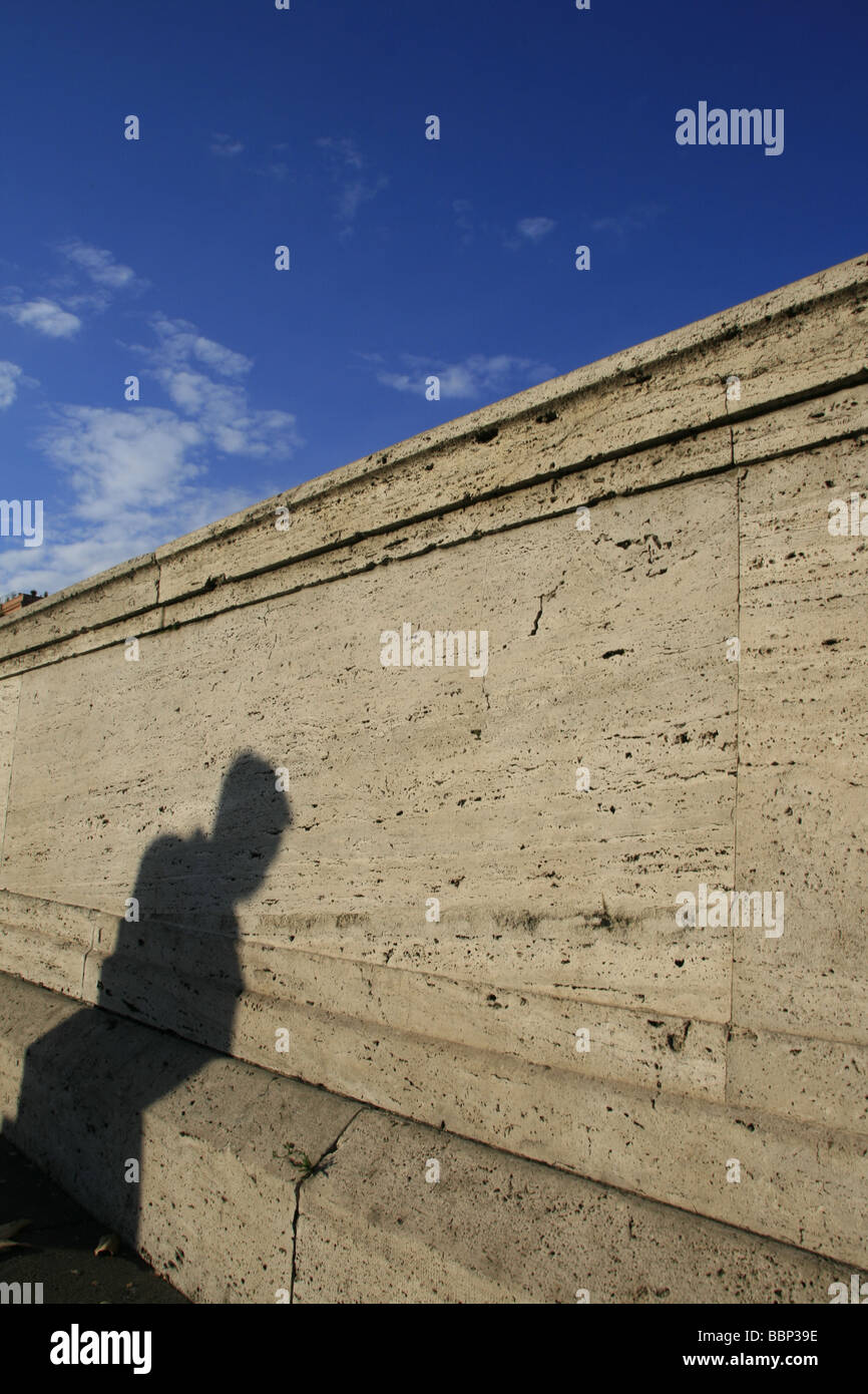one person's shadow on wall in city town Stock Photo - Alamy