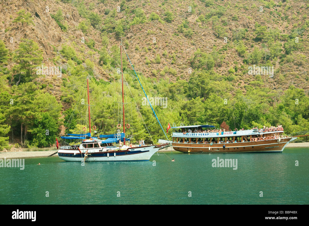 Yacht and trip boat near island Stock Photo - Alamy