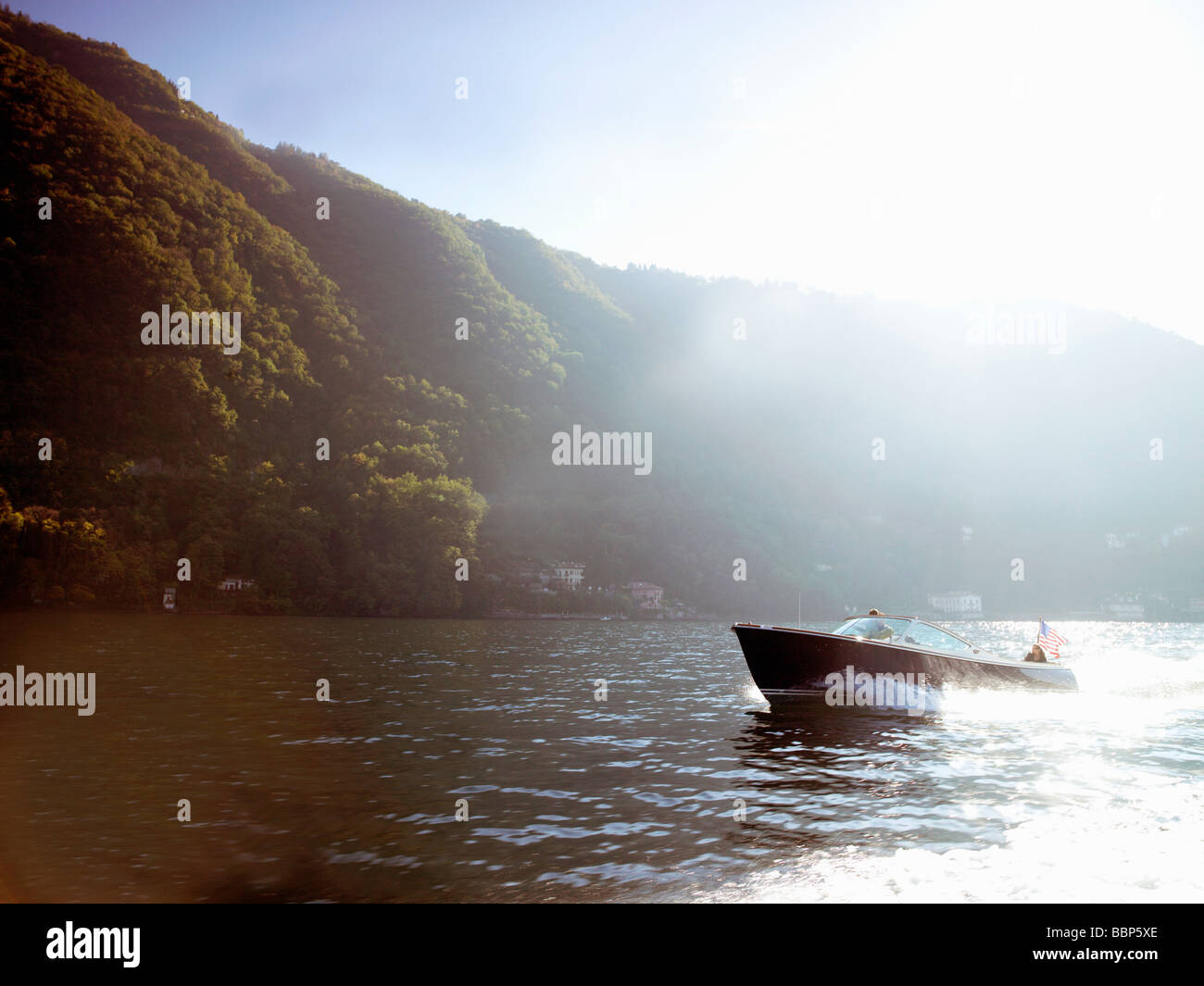 Motorboating vintage boat lake coma italy Stock Photo - Alamy