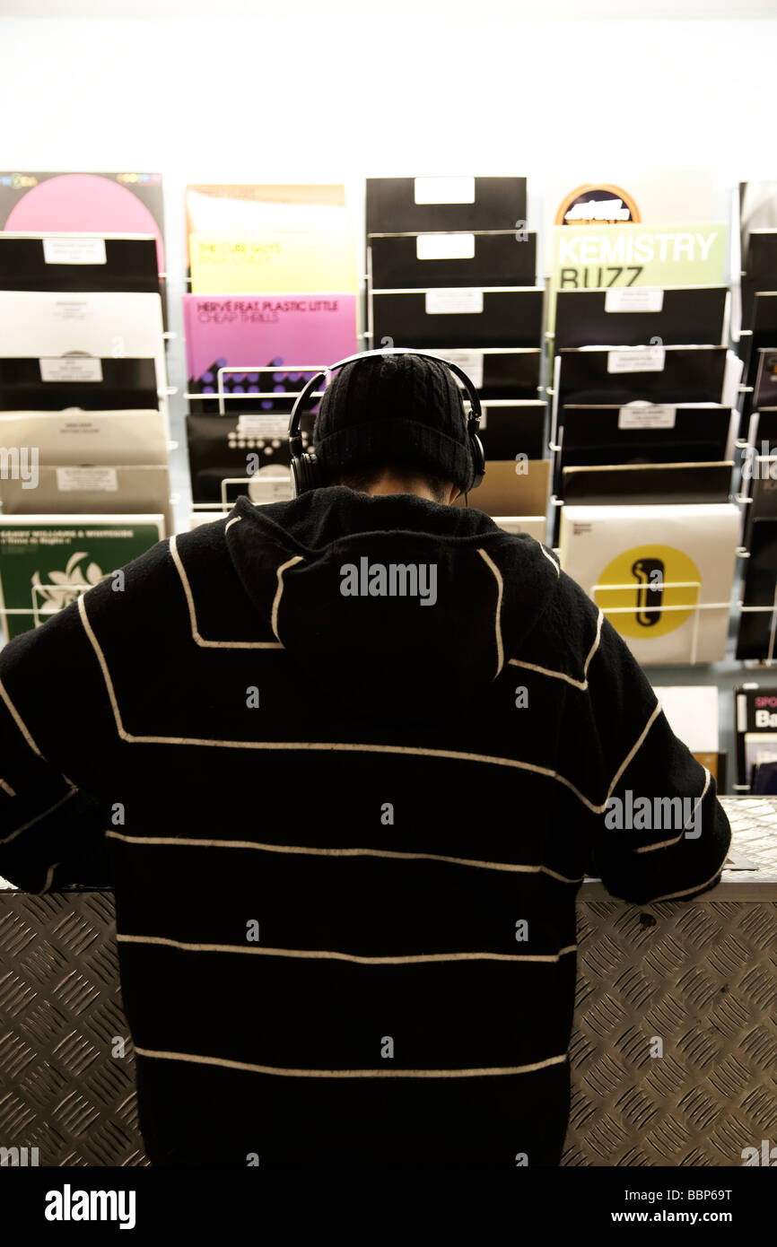 Man listening to records in a record shop Stock Photo - Alamy