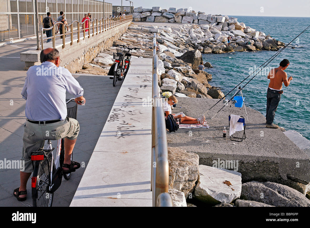 THE BEACH OF MARINA DI CARRARA BORDERED BY A BLOCK OF WHITE MARBLE ...
