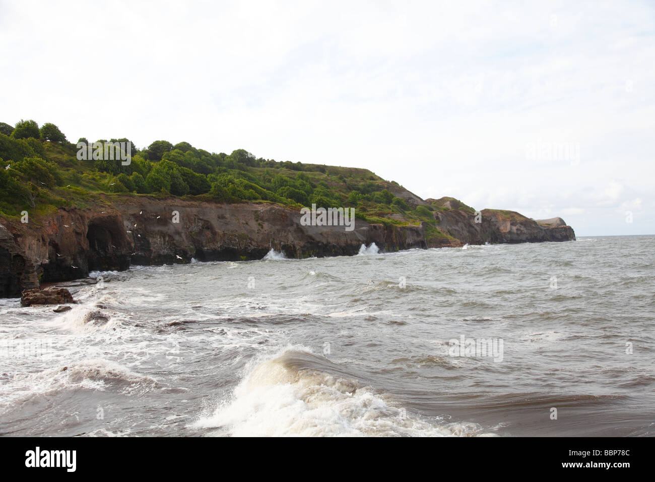Sandsend of Whitby shaw and cliffes with rough seas Stock Photo - Alamy