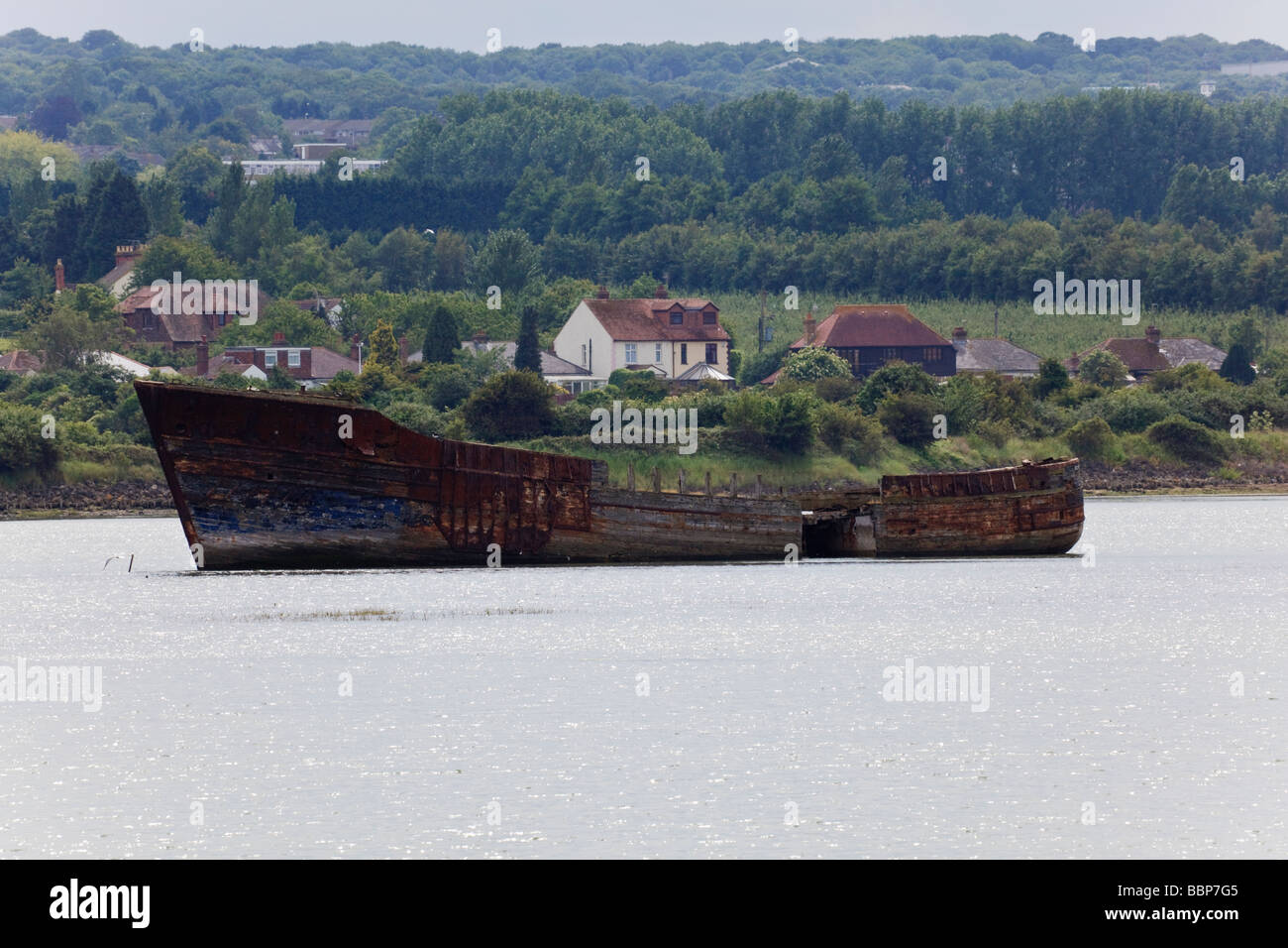 The Carcase of a wooden Hulk ship dominates the view of the houses of ...