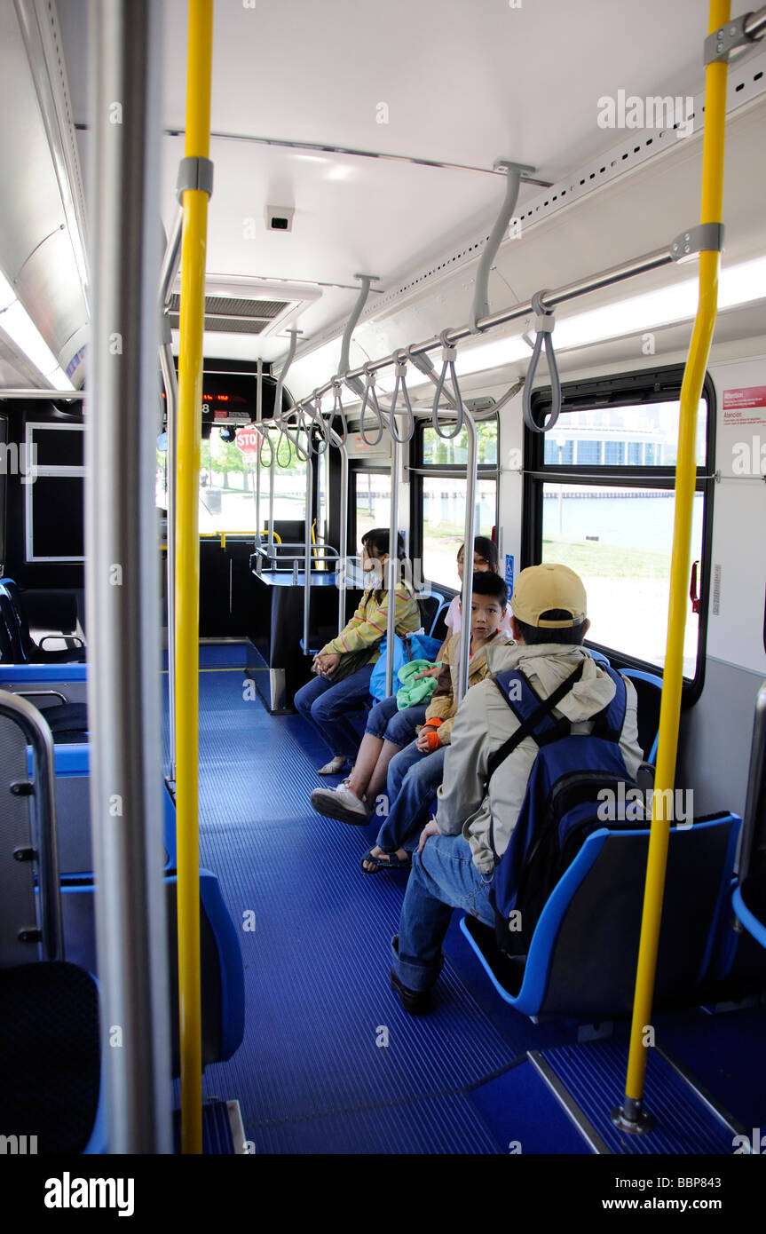 Interior of american bus with seated passengers Stock Photo - Alamy