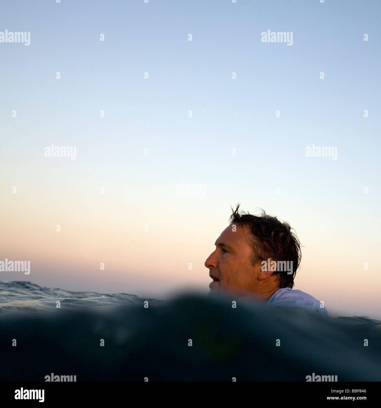 Man raising hand over waves ocean sea Stock Photo - Alamy