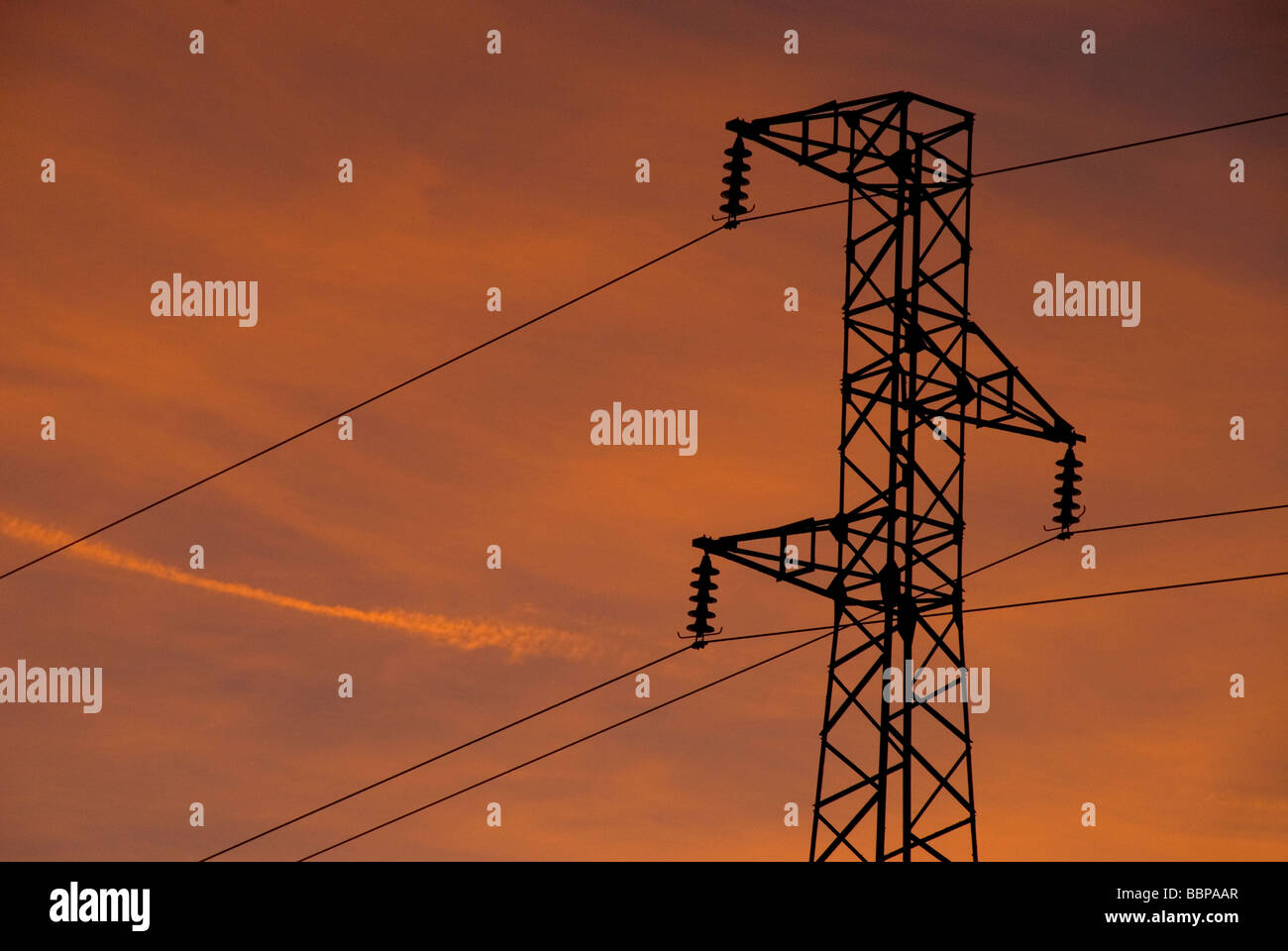 Electricity pylon against the sunset in France Stock Photo - Alamy