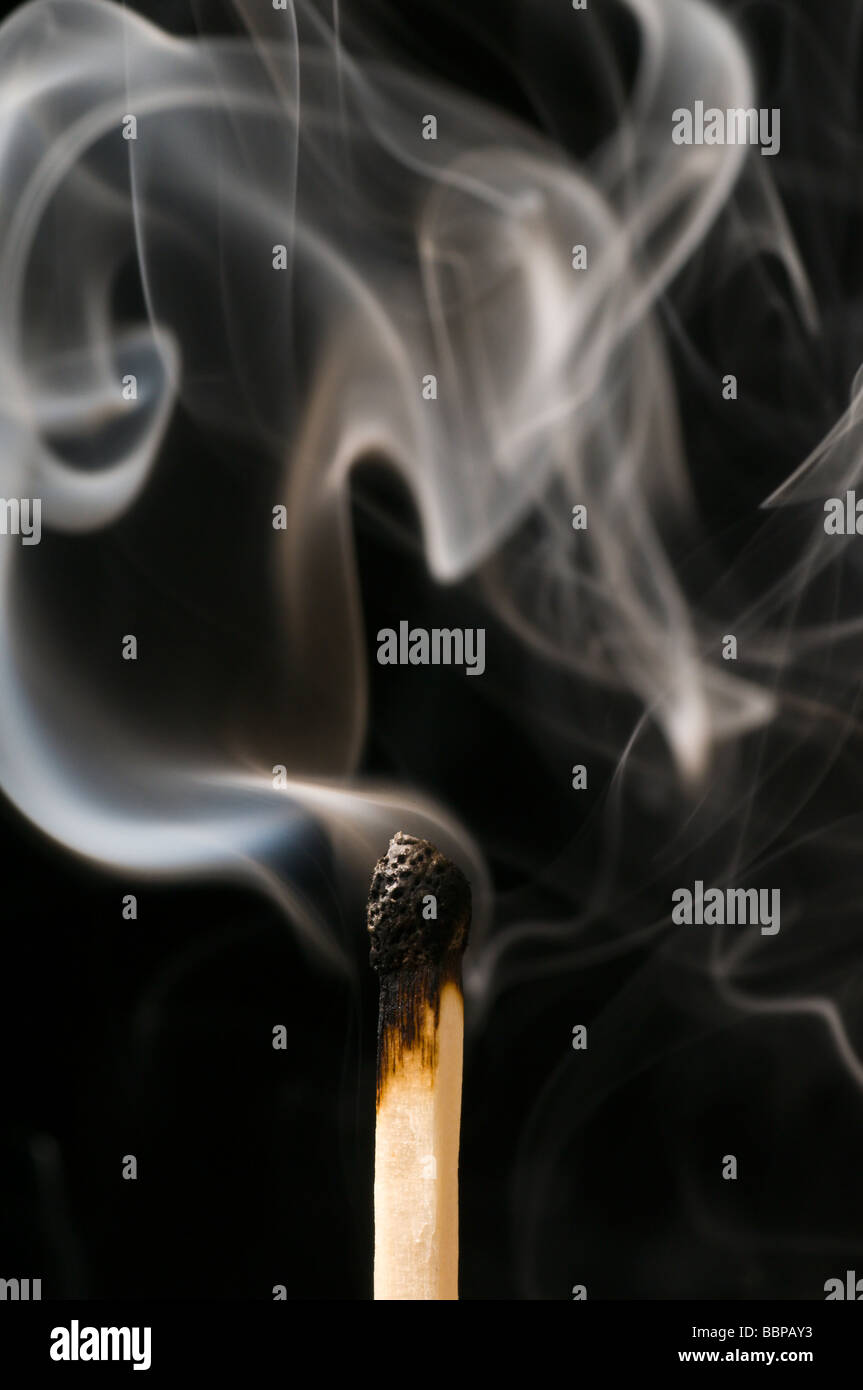 A close up of smoking Match on a black background Stock Photo - Alamy