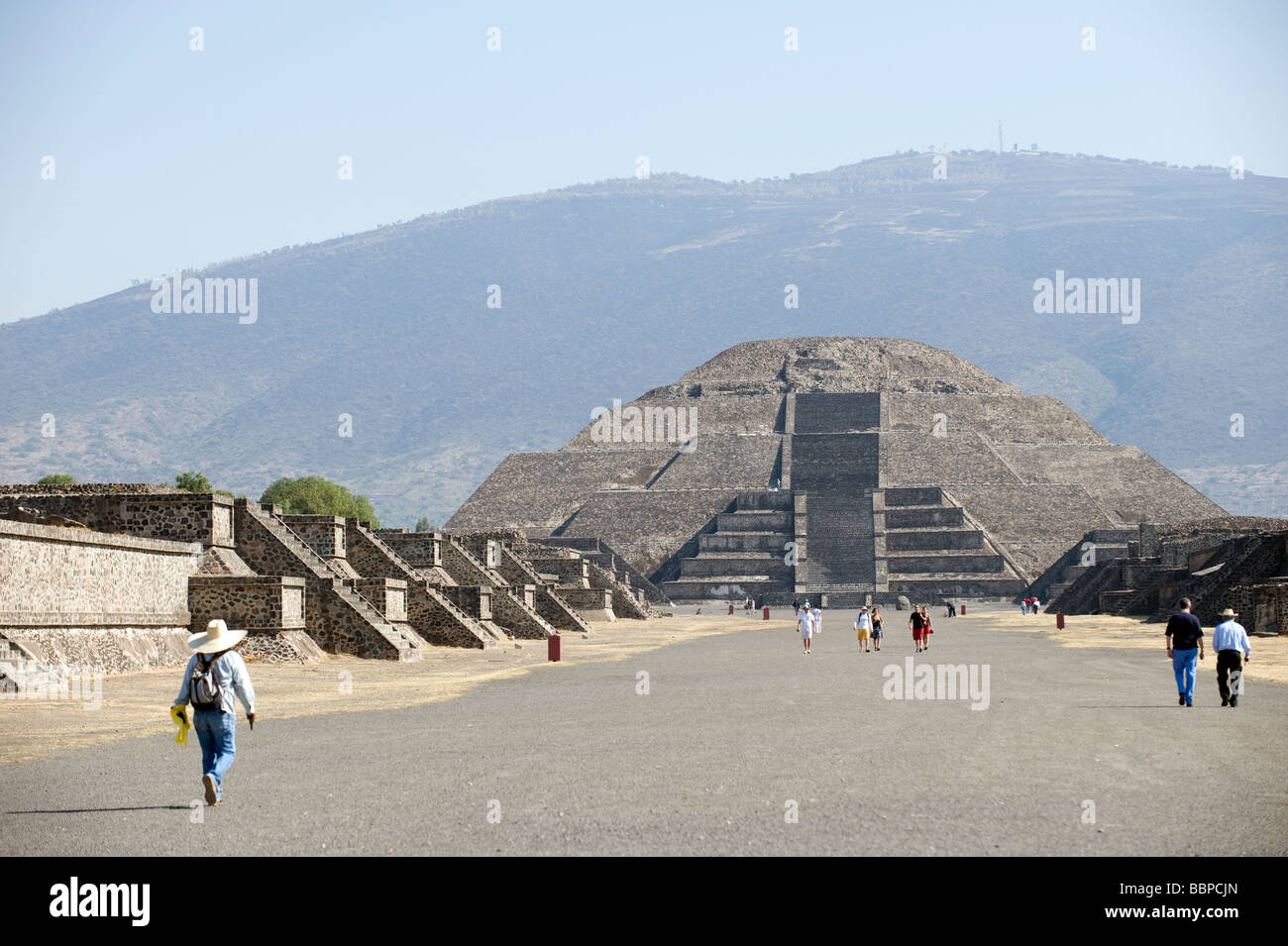 Tourists walk toward The Pyramid of the Moon at Teotihuacan in Mexico ...