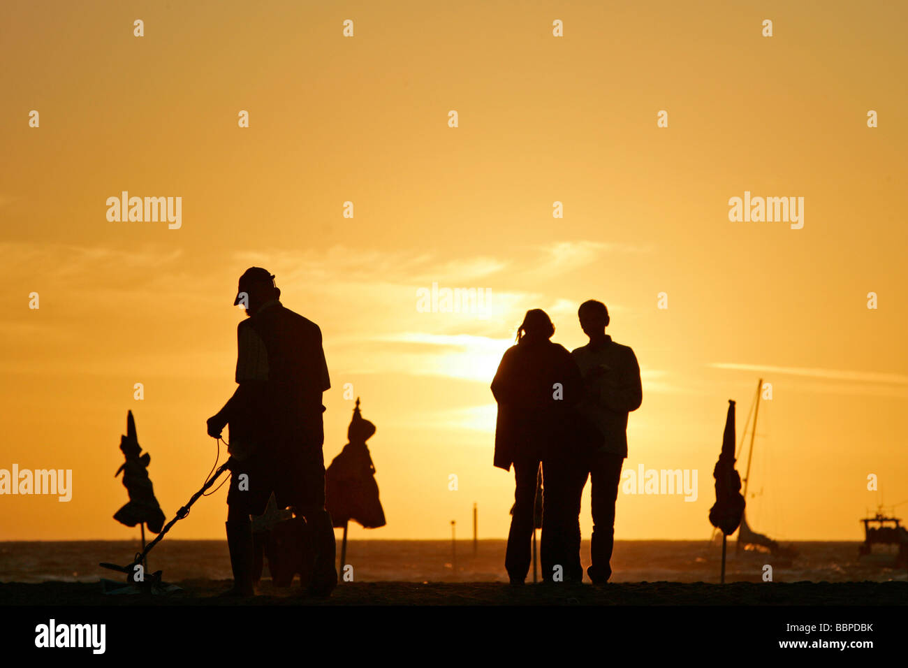COUPLE AND A METAL DETECTOR, SUNSET, THE BEACH IN TROUVILLE-SUR-MER ...