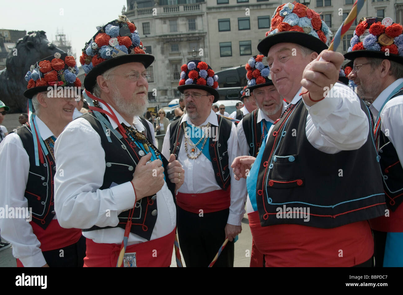 A side in red and blue decorated hats at the annual Morris Dancing ...