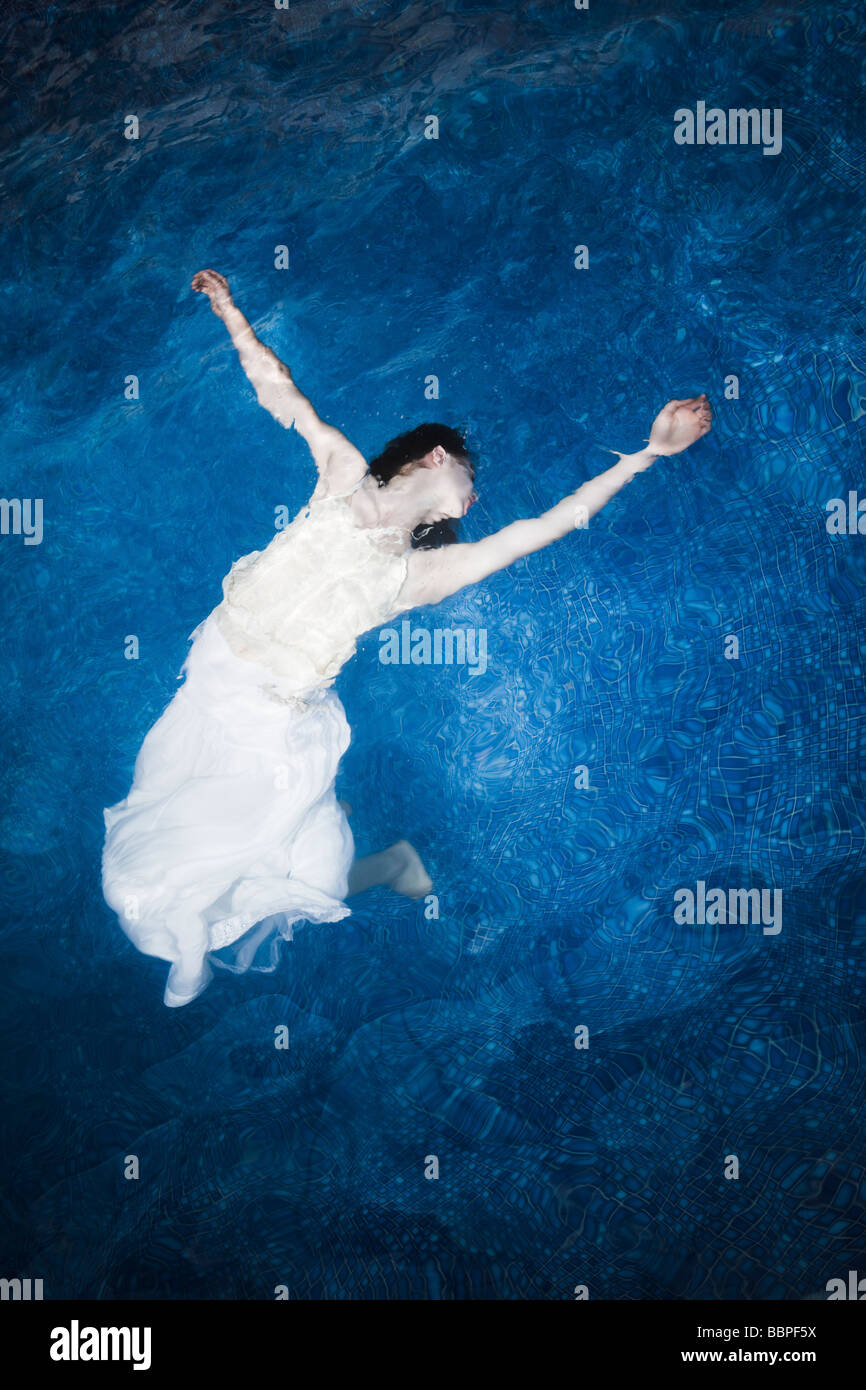 Girl floating in water Stock Photo - Alamy