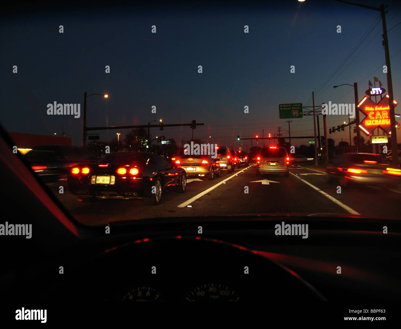 View from drivers seat of driving thru intersection, blurred speed ...