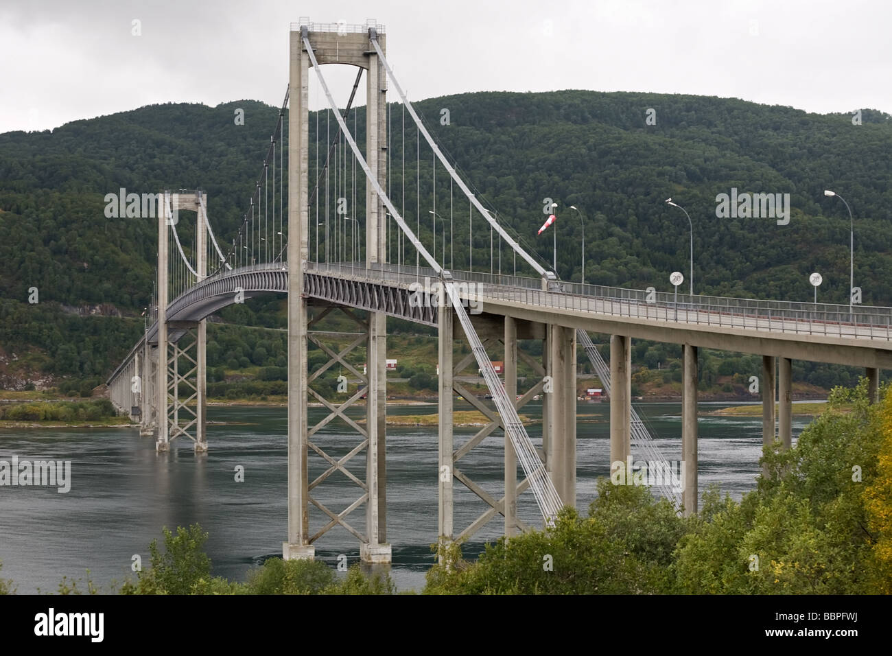 automobile bridge through river against mountains and cloudy sky Stock ...