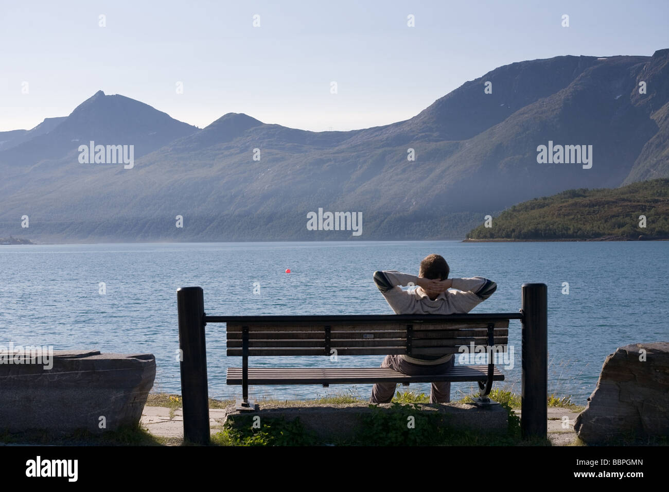 relaxed man sitting on the bank of lake Stock Photo - Alamy