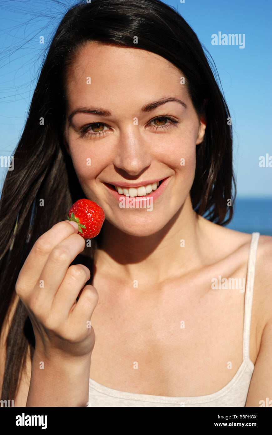 Young woman enjoying a healthy snack Stock Photo - Alamy