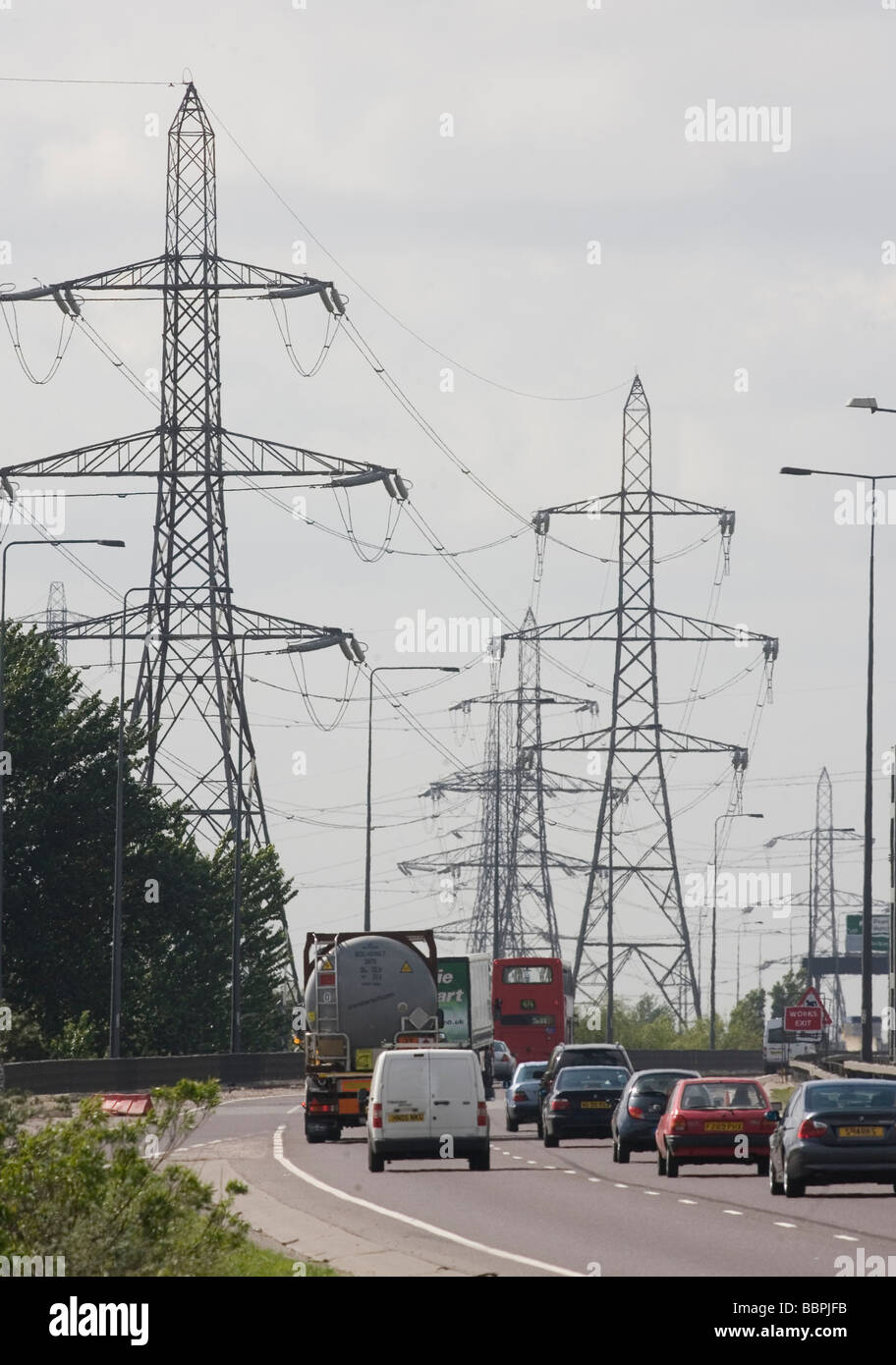Cars travel down the A13 with electricity pylons part of the National ...