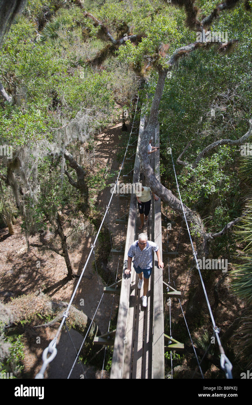 Tourists cross the canopy walkway leading to the canopy tower at Myakka ...