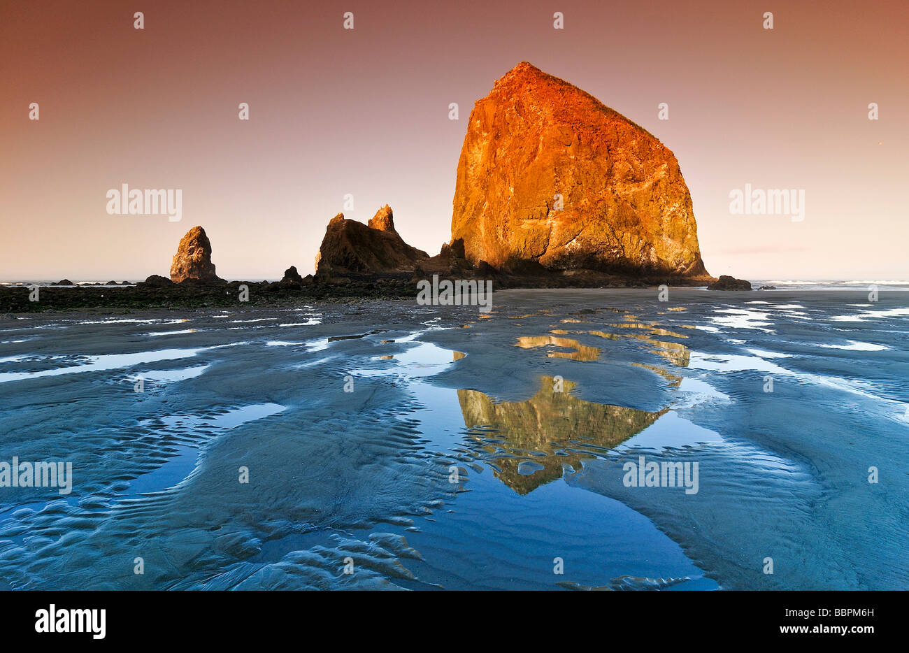Famous Haystack Rock, monolith, solidified lava rock reflected in the ...
