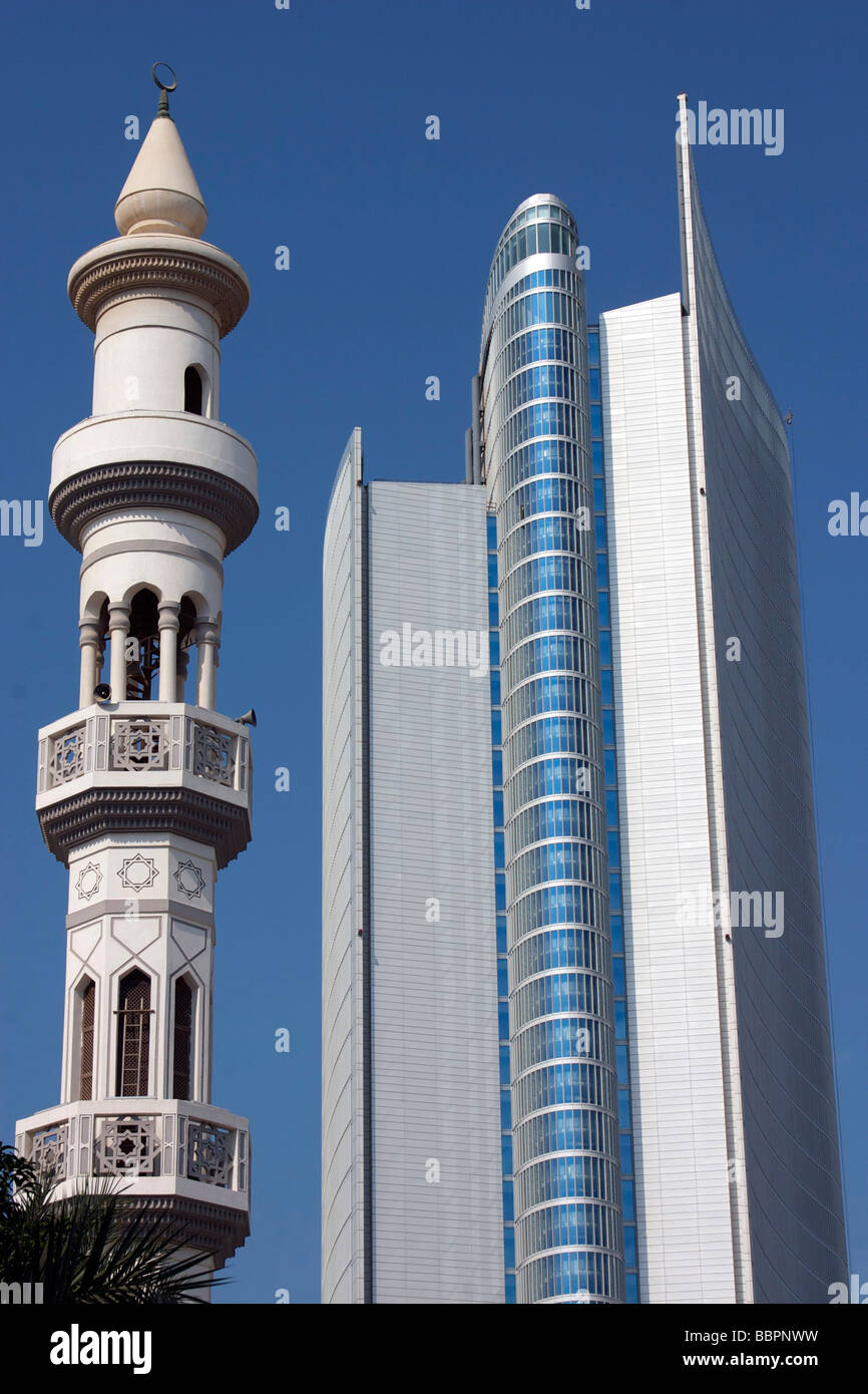 CONTRAST BETWEEN THE MINARET OF A TRADITIONAL MOSQUE AND THE MODERN ...