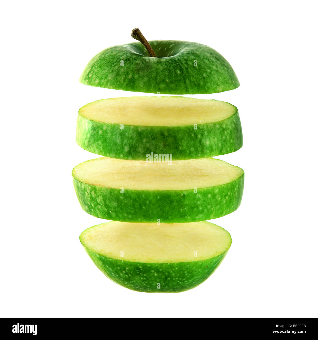green apple cut into slices isolated over a white background Stock ...