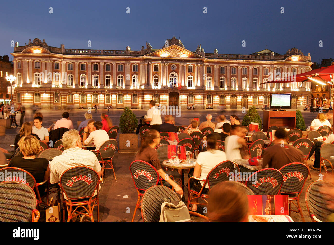 SIDEWALK CAFES UNDER THE ARCHES ACROSS FROM THE TOWN HALL AT NIGHTFALL ...