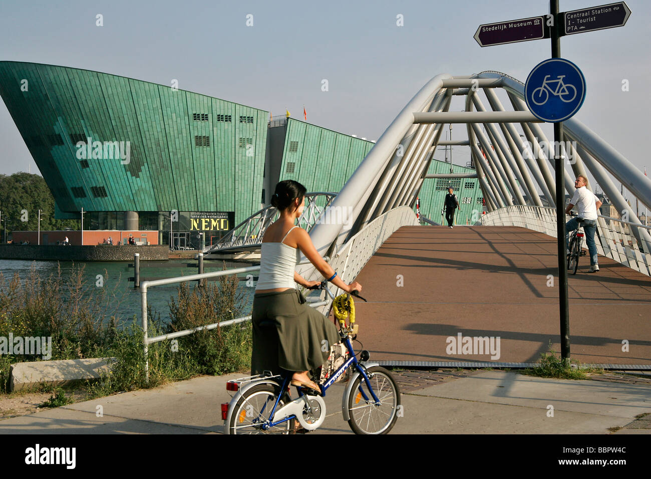 BIKE RIDE BY THE SCIENCE CENTER 'NEMO', SIMILAR TO A GREEN VESSEL, A ...