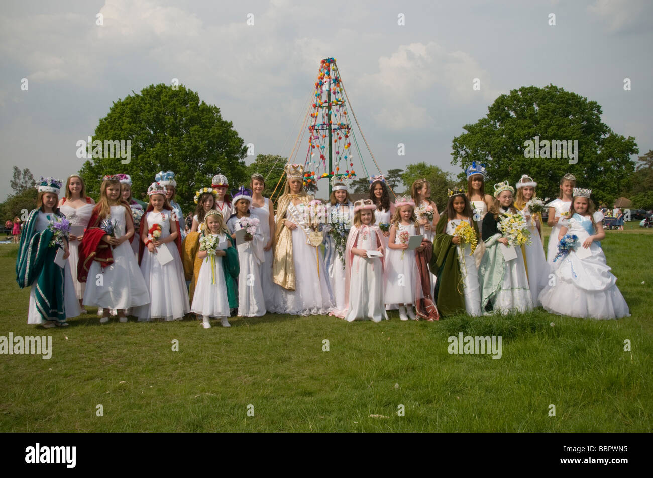 May Queens pose for photographs in front of maypole at Merrie England ...