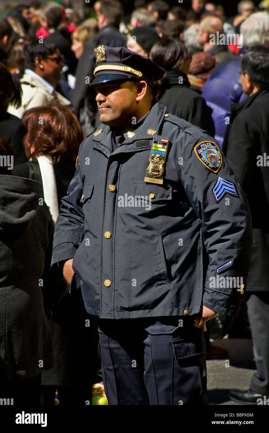 A police sergeant is on duty at the Easter Parade on Fifth Avenue New ...
