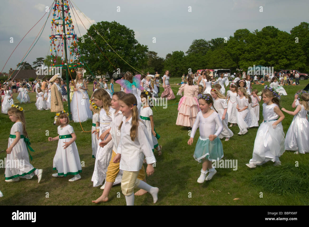 Everyone dances around the maypole at the Merrie England and London May ...